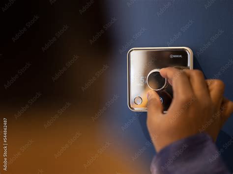 Man Using Thermostat At Home Stock Foto Adobe Stock