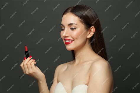 Premium Photo Attractive Young Brunette Woman With Red Lipstick On Black Background