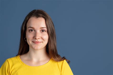 Closeup Portrait Of Young Beautiful Girl Wearing Yellow Shirt Isolated