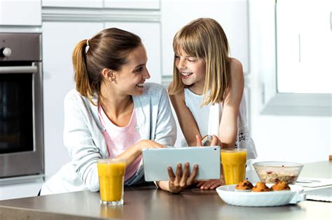 Ibu Muda Cantik Dan Putrinya Menggunakan Tablet Digital Saat Sarapan Di