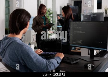 Asian Programmer Analyzing Compiling Html Code On Computer Display