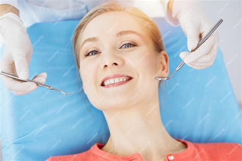 Premium Photo Happy Smiling Woman Is Being Examined By Dentist At