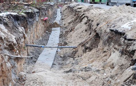 An Excavated Trench With Underground Cables Electricity And