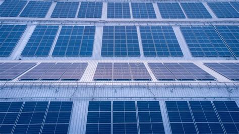 A Large Solar Cell Roof On An Industrial Building Generating Electricity For The Plant During