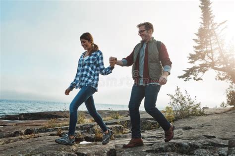 Watch Your Step Babe A Happy Couple Out Hiking Hand In Hand Stock Photo Image Of Outside