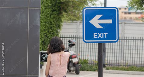 Woman Standing With Her Back At The Blue Exit Sign Metal Exit Sign Parking Exit In The Condo
