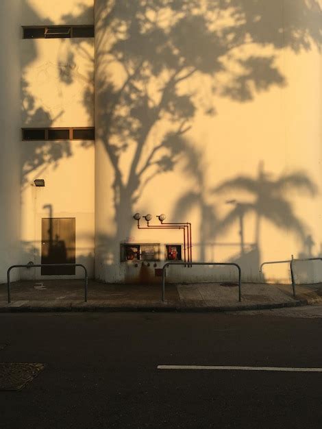 Premium Photo City Street Against Sky At Sunset With Shadow Casted On The Wall