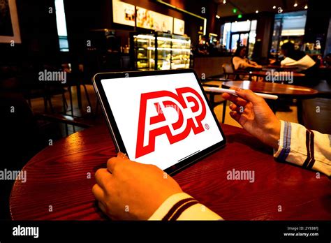 In This Photo Illustration An Adp Automatic Data Processing Logo Is Displayed On The Screen