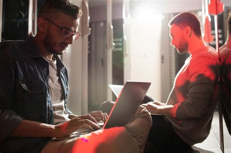 Premium Photo Programmers Using Laptops In Server Room