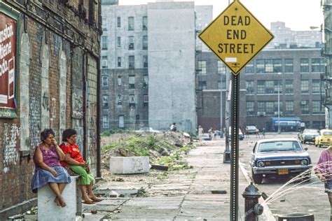 Dead End Street” Women Sitting In Front Of Abandoned Building On