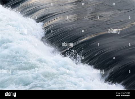Rapid Water Flow Over Barriere River Overflow Over Dam Close Up With Splash And Foam Abstract