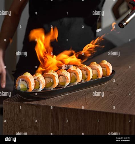 Restaurant Chef Cook Preparing Salmon Filet Flambe In Open Kitchen Stock Photo Alamy