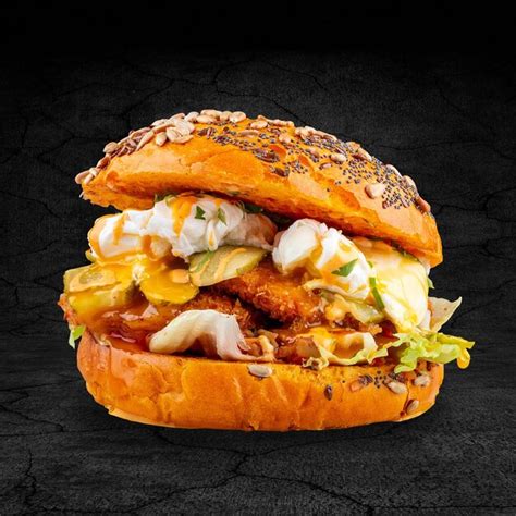 Premium Photo Burger With Chicken Poached Egg And Cheddar Cheese In A