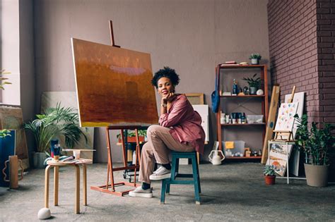 핑크 셔츠를 입은 아름다운 아프로 여성 아티스트 그녀의 홈 스튜디오에서 캔버스에 그림 예술가에 대한 스톡 사진 및 기타 이미지 예술가 여자 화가 예술가 Istock