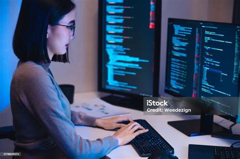 Asian Woman Software Development Working On Coding Computer Screen And Flowchart At Night In