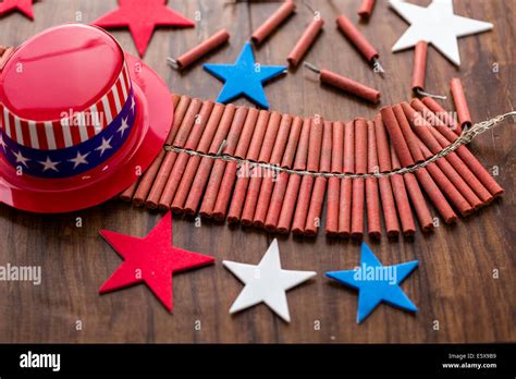 Roll Of Firecrackers With Red White And Blue Stars On Wood Table Stock
