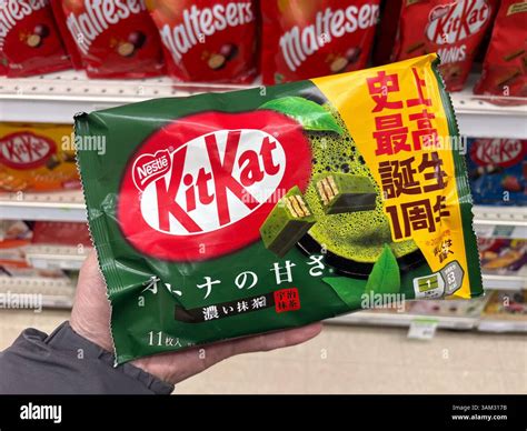 A Hand Holding A Kit Kat Matcha Green Tea Flavor From Japan In Its