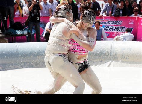 Two Chinese Women Wrestle In A Mud Pool During An Interntional Womens