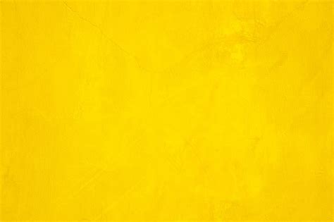 텍스처 배경에 대한 콘크리트 벽 노란색 색상 추상 그런지 밝은 다채로운 색상 배경 성장 효과 파스텔 옐로우 컬러의 로우 콘트라스트는 거칠고 요철이 특징입니다 노란색 배경에