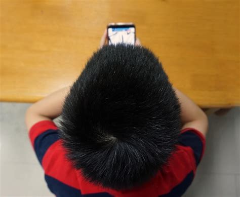 Premium Photo Directly Above Shot Of Boy Using Mobile Phone