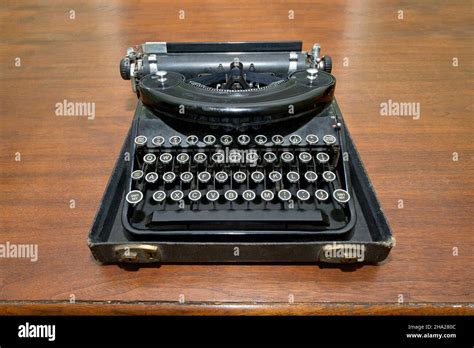 Antique Type Writer Sitting In The Lower Half Of Carrying Case On An