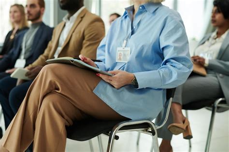Premium Photo Cropped Shot Of Female Learner Making Notes In Copybook At Lecture