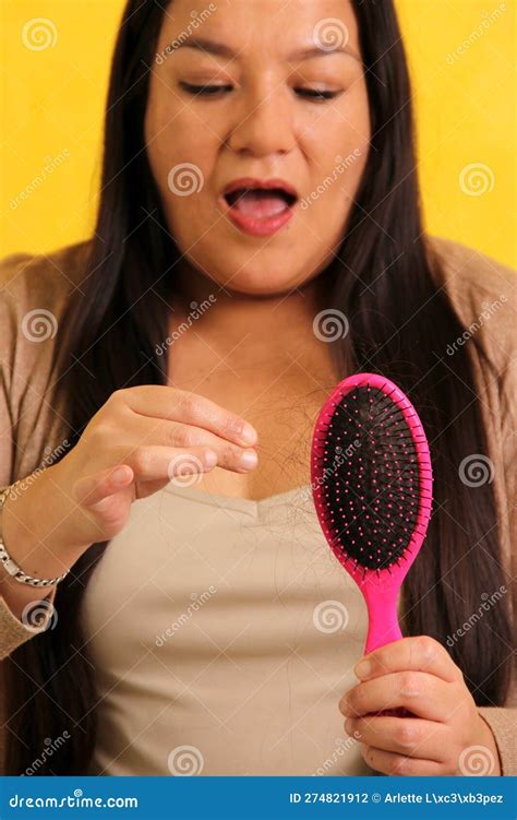 Woman With Very Long Straight Hair Suffers From Hair Loss Looking At The Brush How Many Hairs