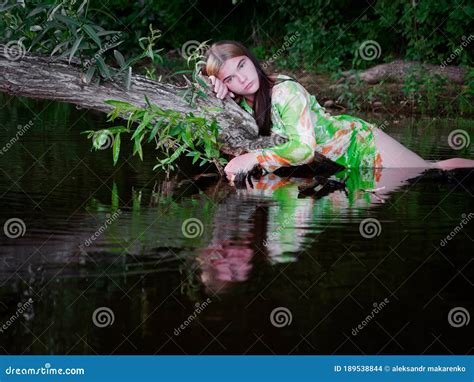 Girl Lies In The Water On A Branch Of An Old Tree Stock Photo Image Of Open Mirror
