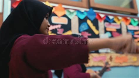 Teacher Pointing To A Board In A Colorful Classroom Setting Stock Video Video Of Culture