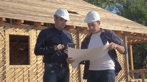 Teamwork Concept Building Constructing Architect Slow Motion Video Two Men Builder In Helmets