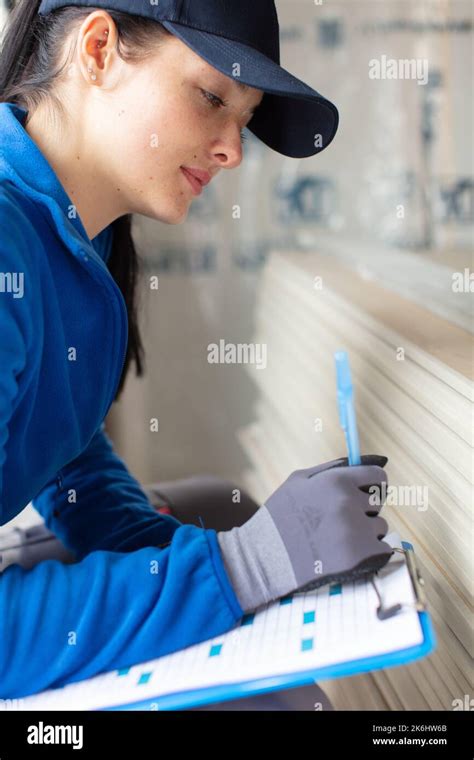 Female Surveyor With Clipboard On Construction Site Stock Photo Alamy
