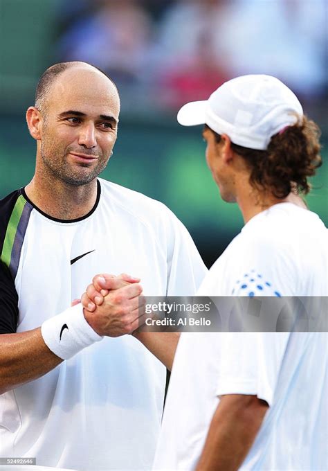 Andre Agassi Of The Usa And Gaston Gaudio Of Argentina Shake Hands