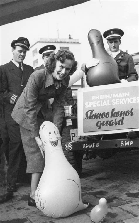 Pilots And A Flight Attendant Present The Inflated Shmoo Shaped