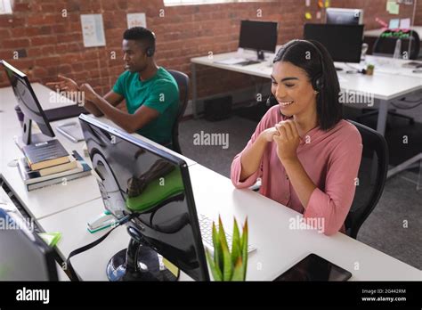 diverse male and female colleagues having video call sitting in front