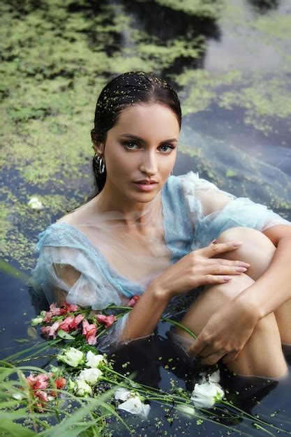 Premium Photo Art Beautiful Romantic Woman Lies In Swamp In Blue Long
