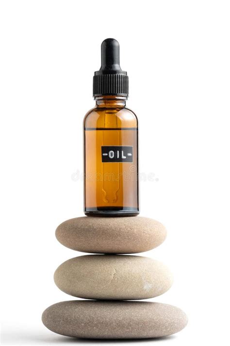Essential Oil In Glass Bottle On Stack Of Pebbles Stock Image Image