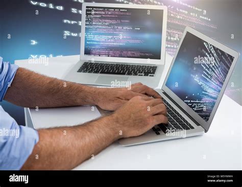 Man Typing Coding Text On Two Laptops Stock Photo Alamy