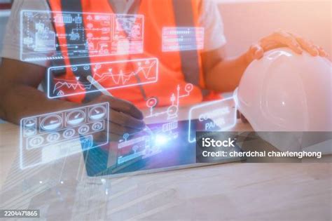 화학 기계 생산의 가상 다이어그램이 있는 디지털 태블릿을 사용하여 안전모 Ppe를 착용하고 현장 사무실에서 테이블에서 작업하는 엔지니어 개념에 대한 스톡 사진 및 기타