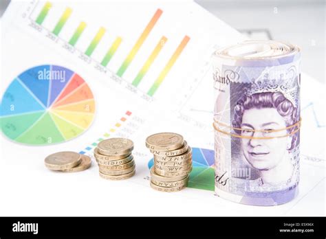 British Pound Coins And Notes With Financial Chart Stock Photo Alamy