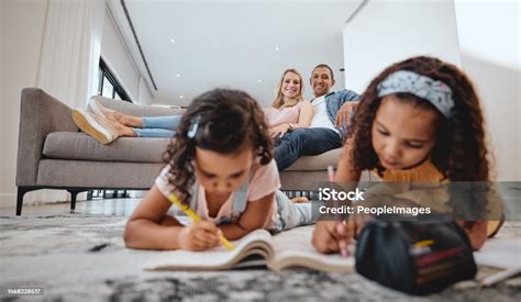 웰빙 휴식 행복한 부모와 함께 거실에서 색칠하기 책을 그리는 아이들과 함께하는 가족 인종 간 어머니와 아버지는 집 소파에서 어린 아이들이 함께 그림을 그리고 유대감을