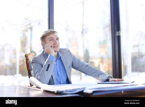 architect calling customer by smartphone and asking about projec stock