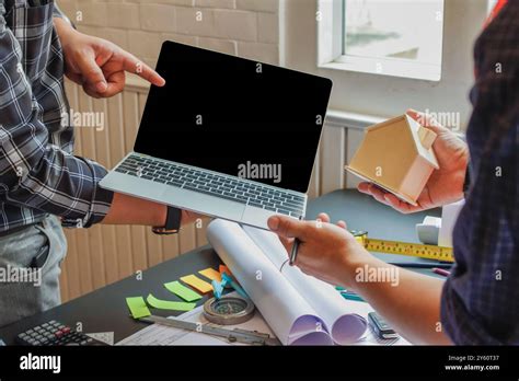 A Team Of Architects And Engineers Discuss With Investors To Design Large Scale Construction