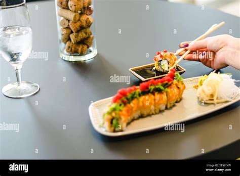 Woman Eating Sushi At A Restaurant Stock Photo Alamy