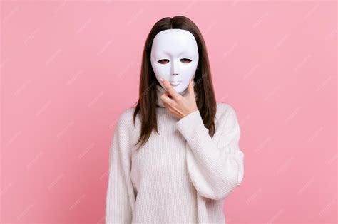 Premium Photo Brunette Woman Covers Face With White Mask Hiding
