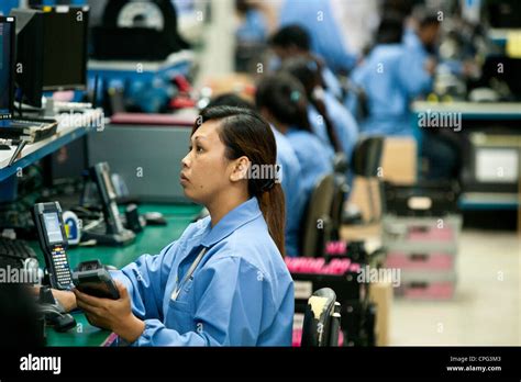Workers Assemble Hand Held Inventory Computer Devices On The Assembly