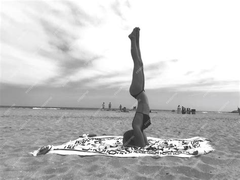 Premium Photo Woman Doing Handstand At Beach Against Sky