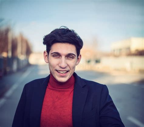 Handsome Young Man In City Street Looking At Camera Smiling Stock