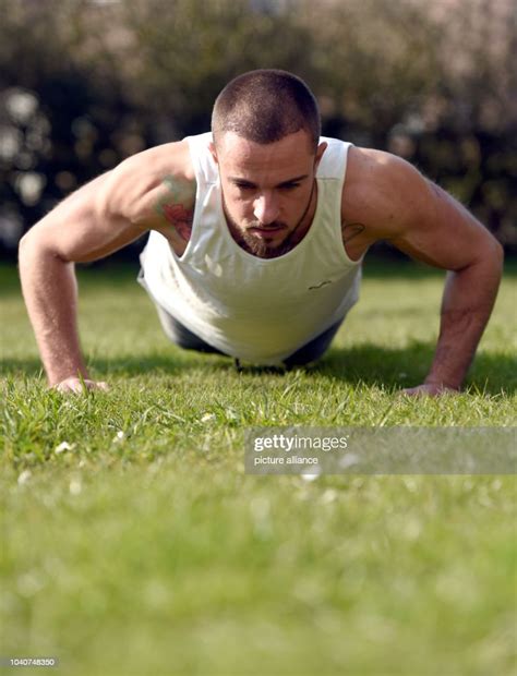 Transgender Model Benjamin Melzer Performs Push Ups In A Garden In