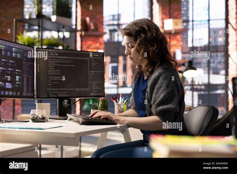 African American Software Engineer Works On Dual Monitors And Typing