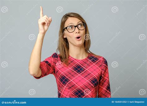 Portrait Of Amazed Pretty Woman Pointing With Finger With Open Mouth
